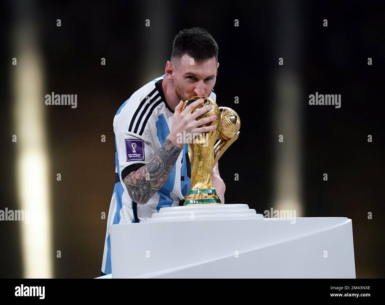 Argentina's Lionel Messi kisses the FIFA World Cup trophy after being ...