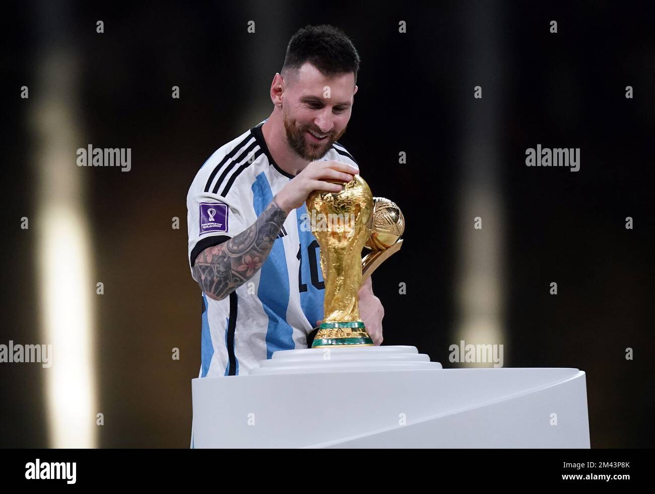 Argentina's Lionel Messi touches the FIFA World Cup trophy after being ...