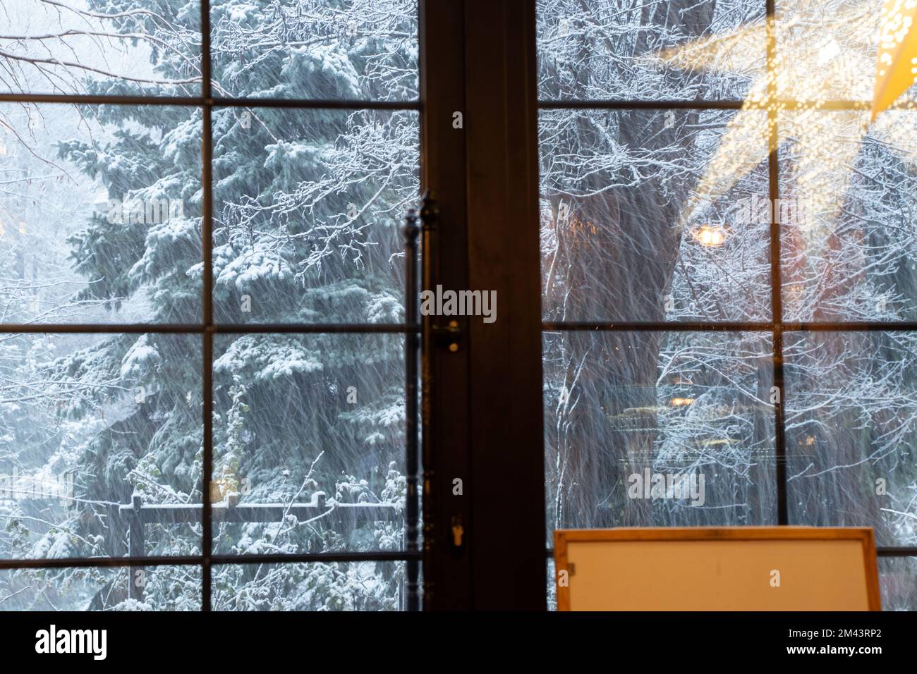 Snowfall outside the window during the day in a city in Ukraine, view ...