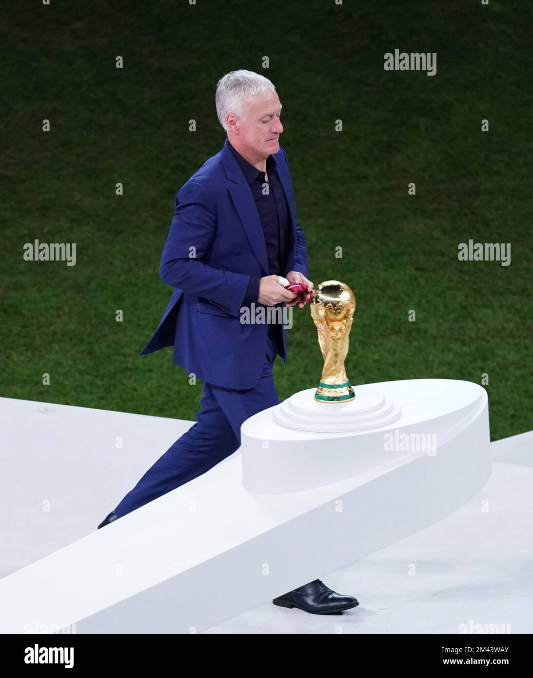 France manager Didier Deschamps walks past The World Cup Trophy after ...