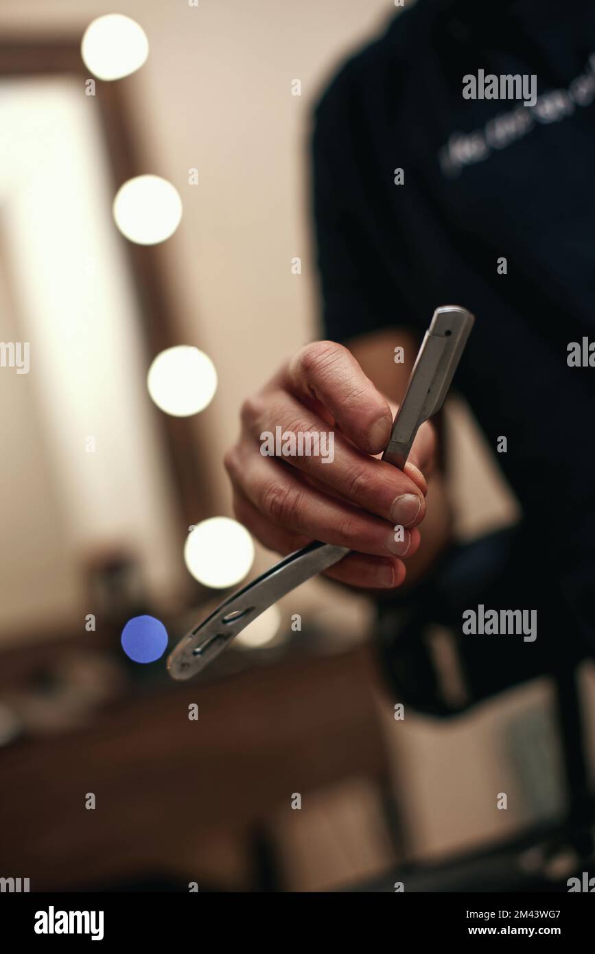 barber hand testing the sharpness of blade Stock Photo - Alamy
