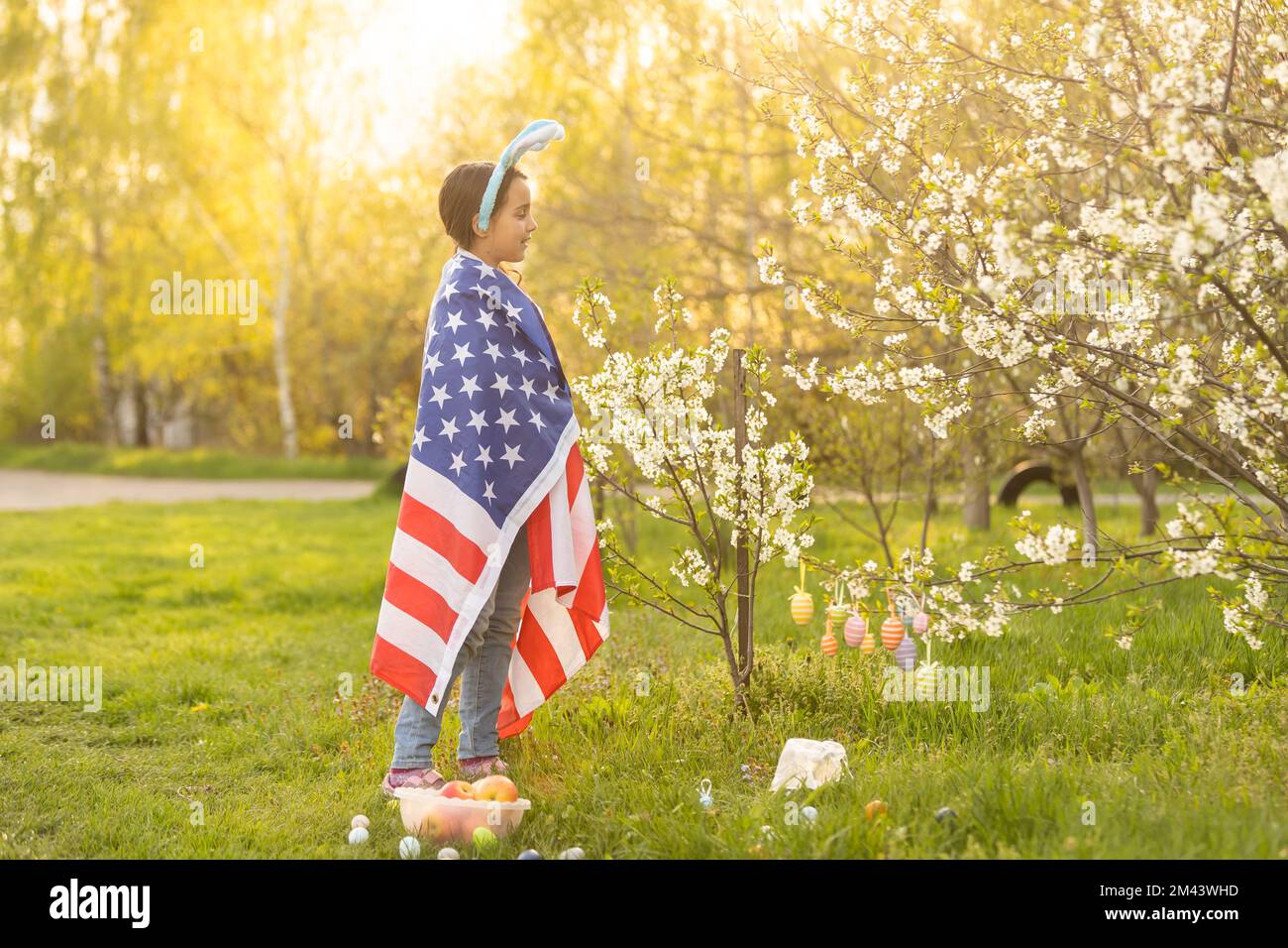Girl kid in rabbit bunny ears on head with colored eggs and american ...