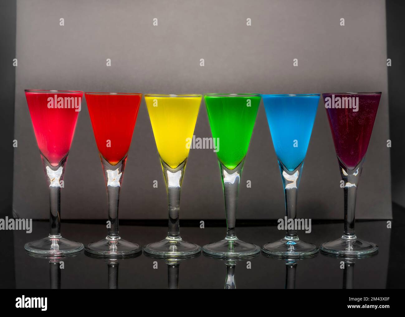Dark black background with color fresh glass shots Stock Photo - Alamy