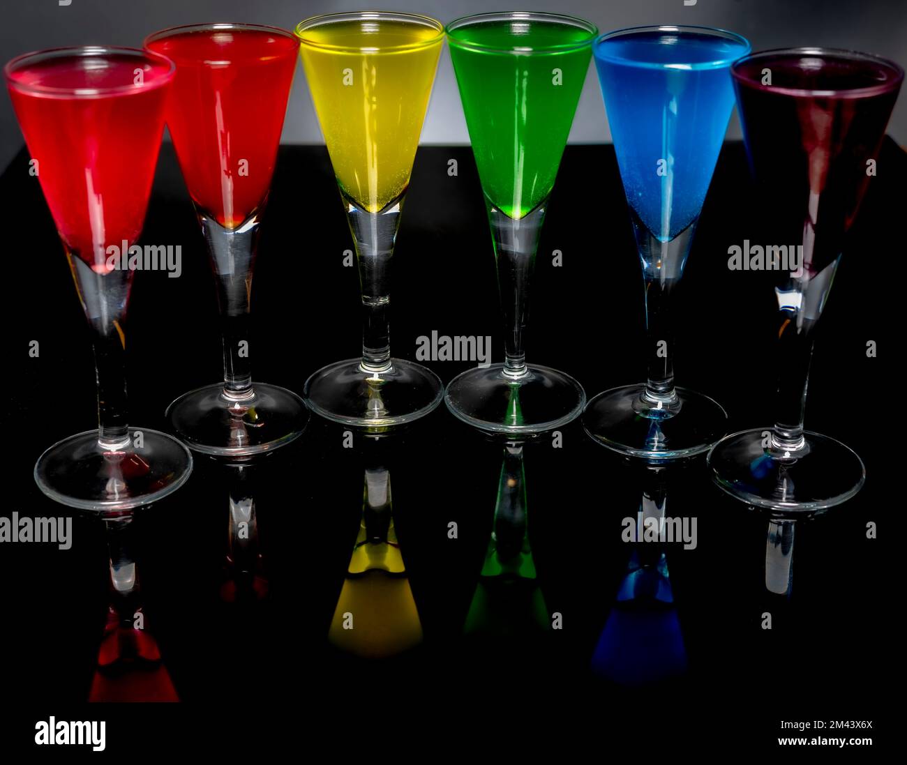 Dark black background with color fresh glass shots Stock Photo - Alamy