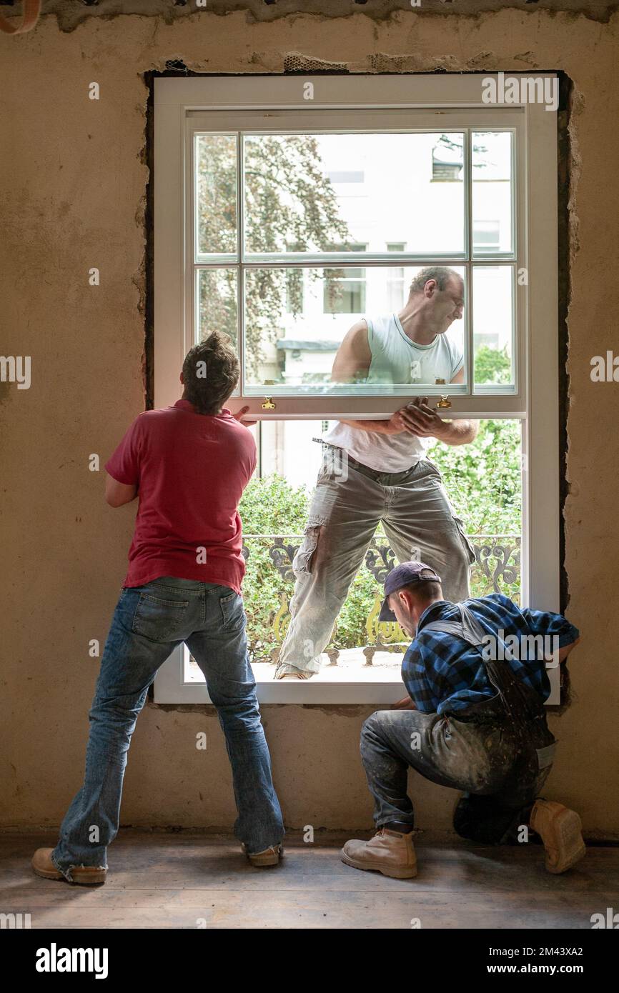 Workers are installing a window Stock Photo - Alamy