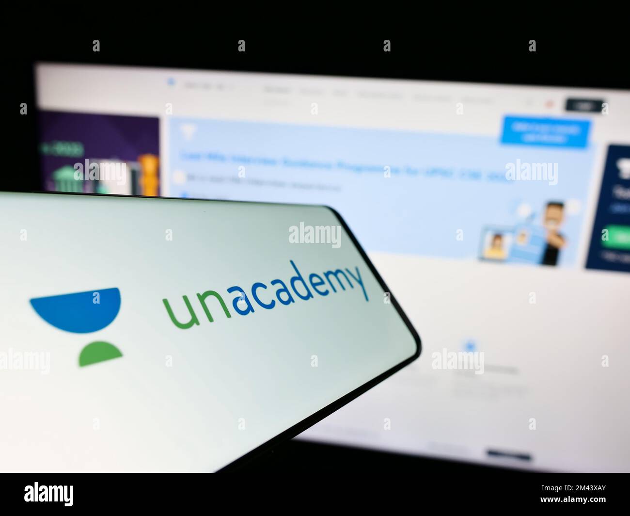 Mobile phone with logo of Indian education company Unacademy on screen ...