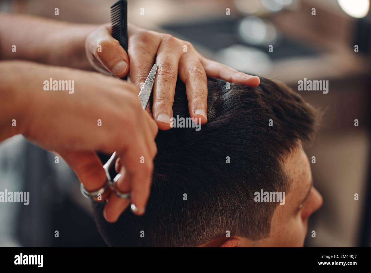 hairdresser does haircut for man in barber shop Stock Photo - Alamy