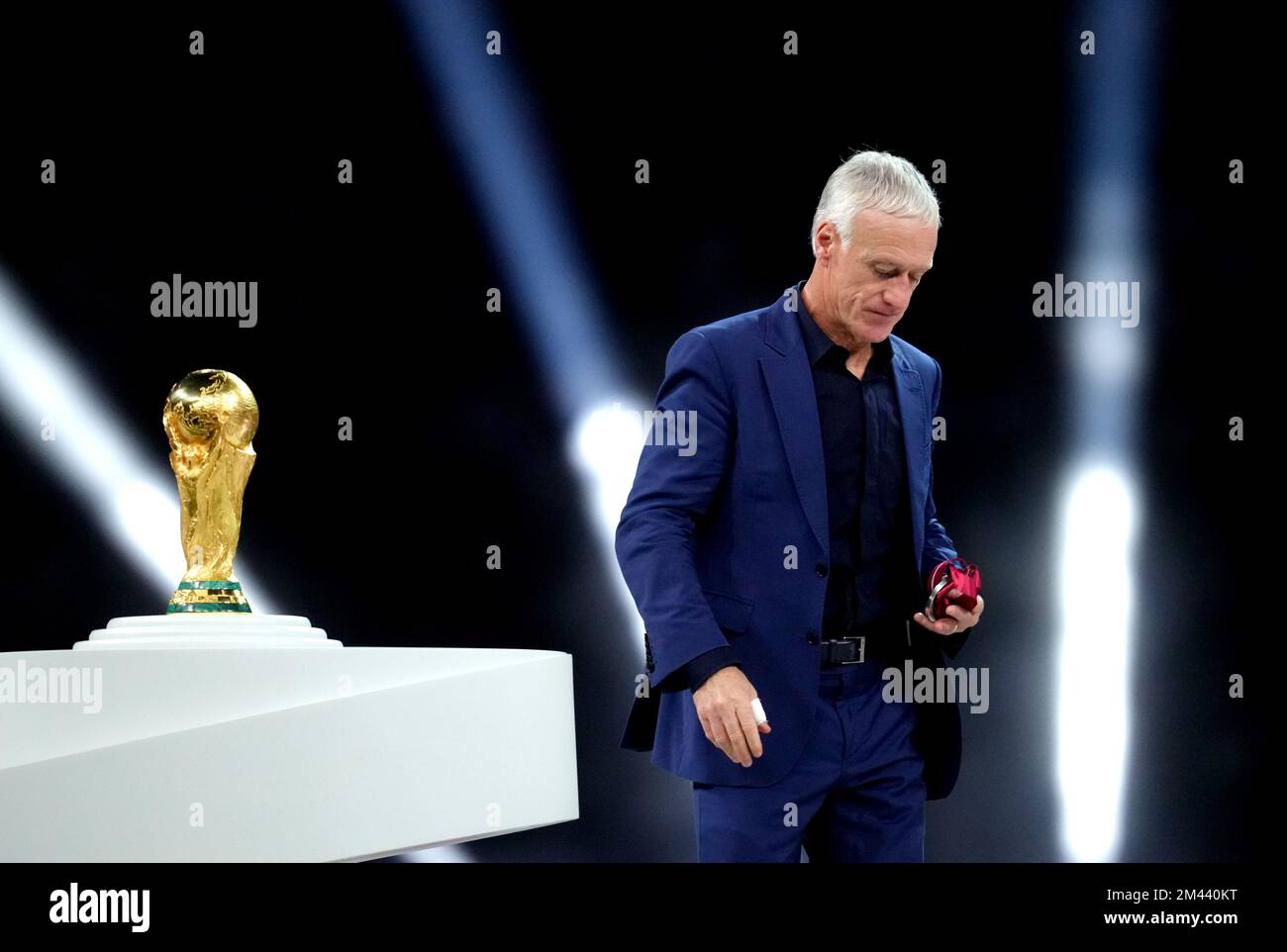 France manager Didier Deschamps walks past the FIFA World Cup trophy ...