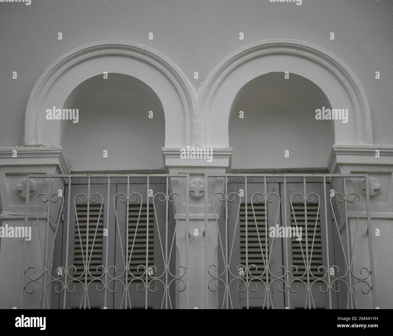 Neoclassical house facade with wooden window shutters and a balcony ...