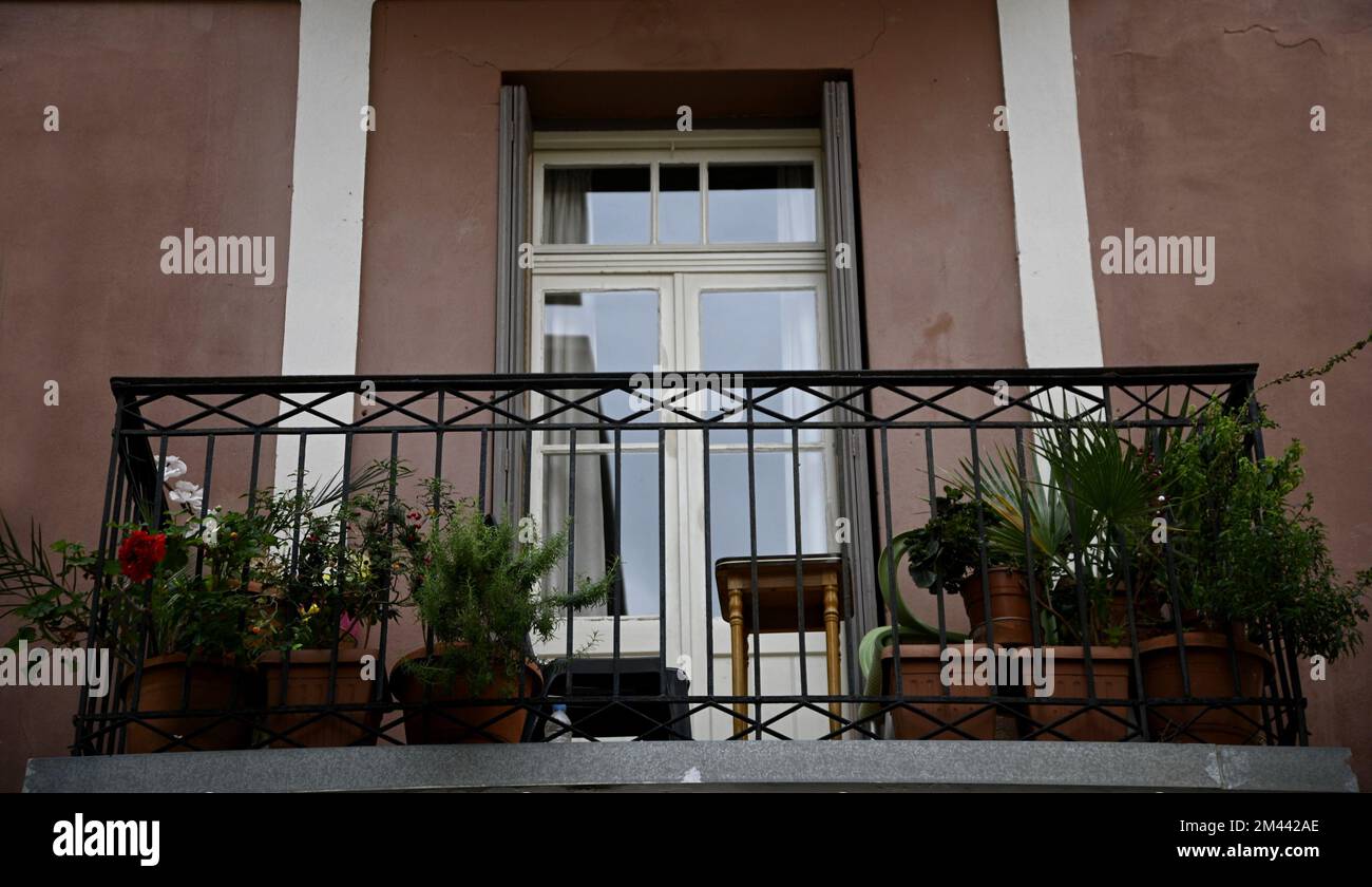 Neoclassical house facade with wooden window shutters and a balcony ...
