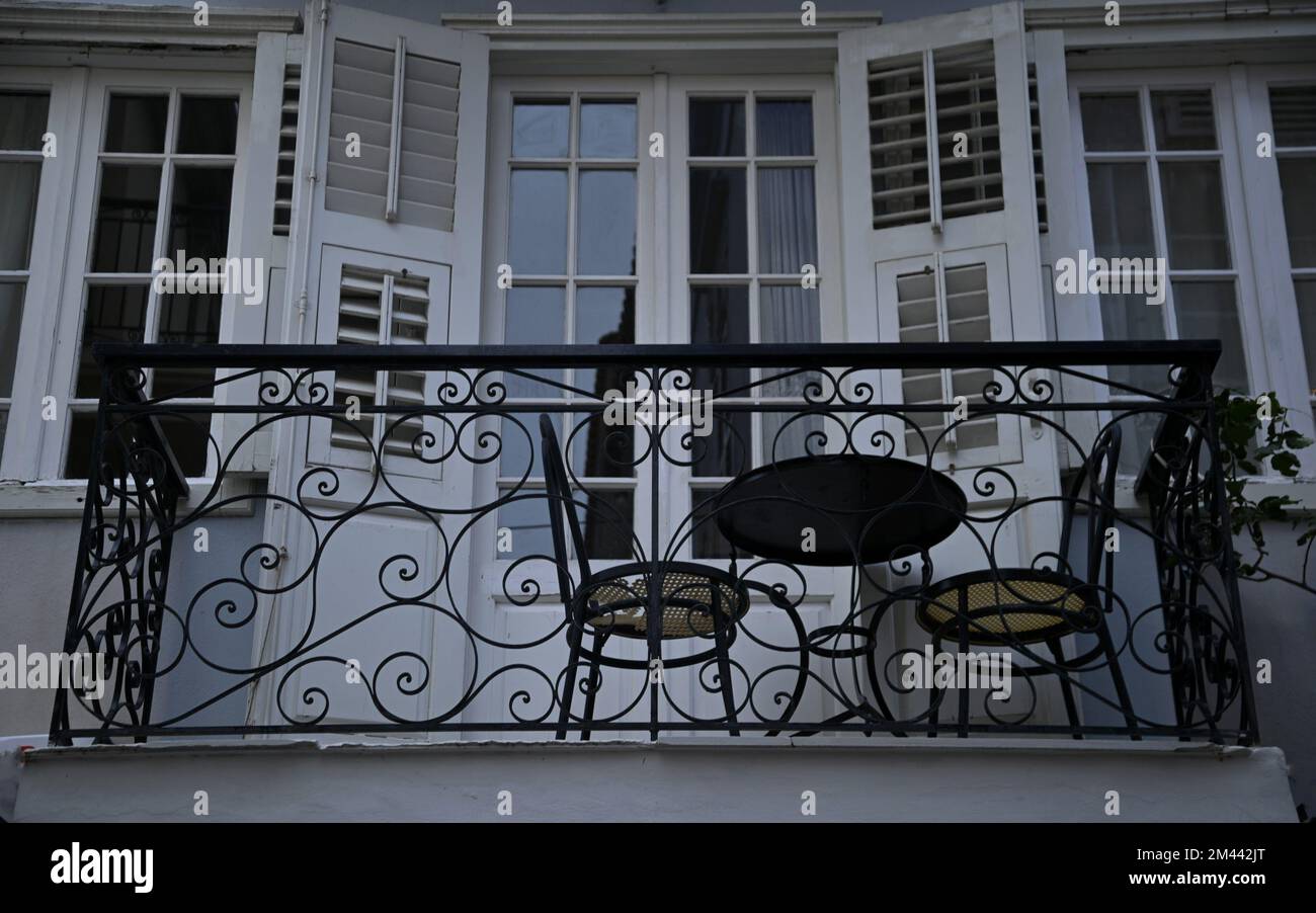 Neoclassical house facade with wooden window shutters and a balcony ...