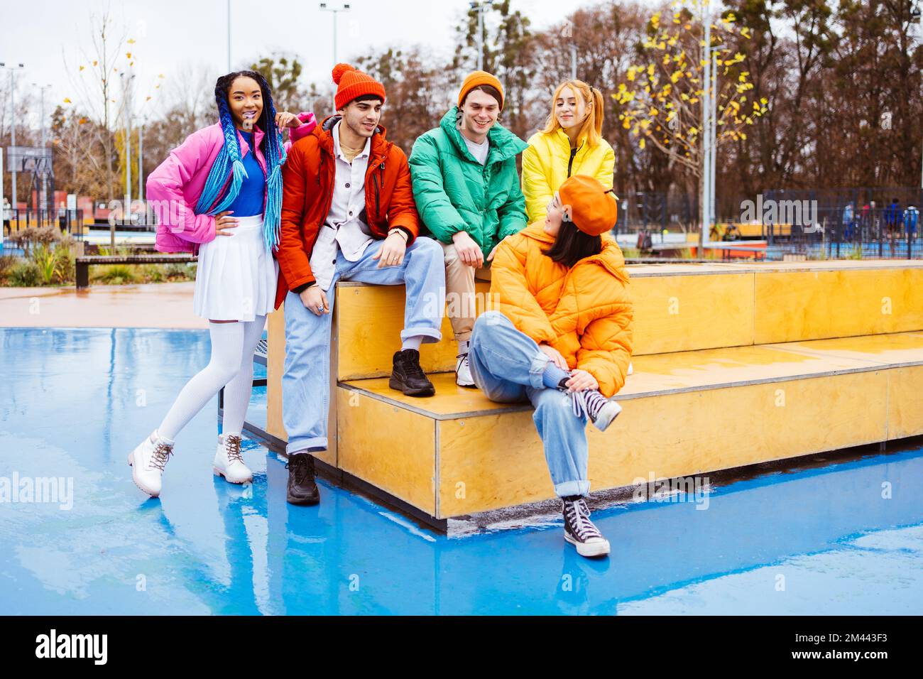 Multiracial group of young happy friends meeting outdoors in winter ...