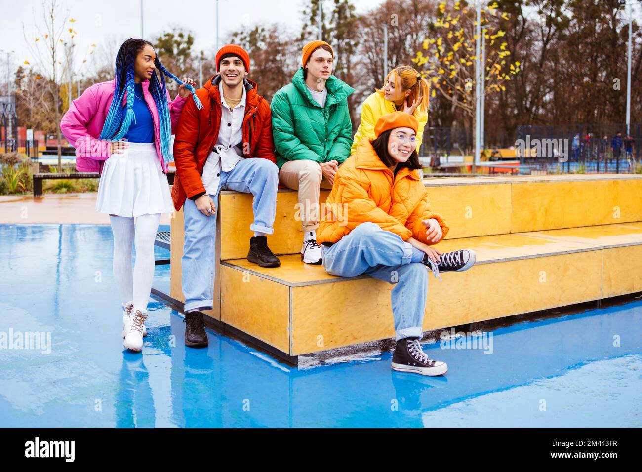 Multiracial group of young happy friends meeting outdoors in winter ...