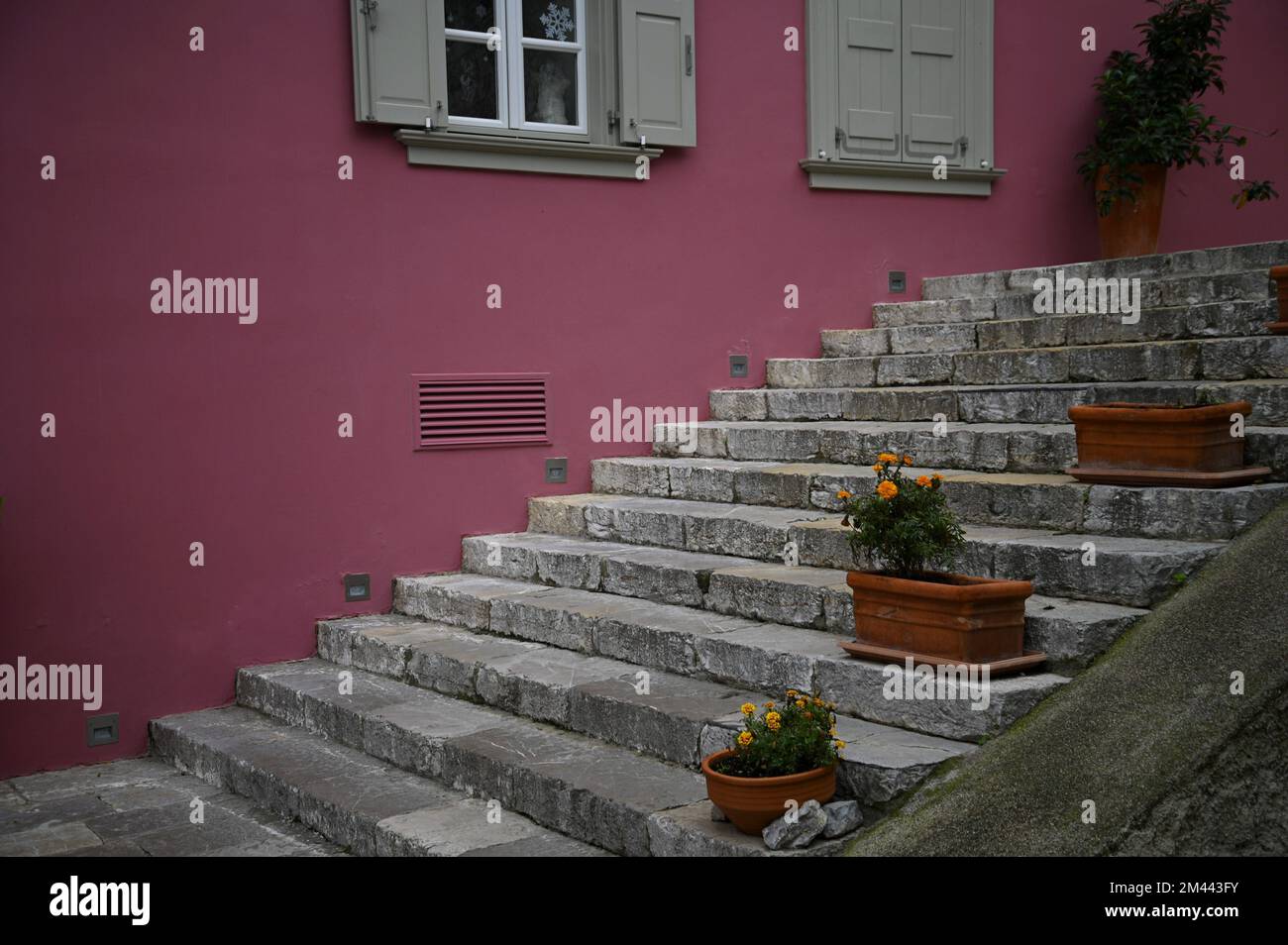 Neoclassical building exterior with a Venetian stucco wall, grey wooden ...