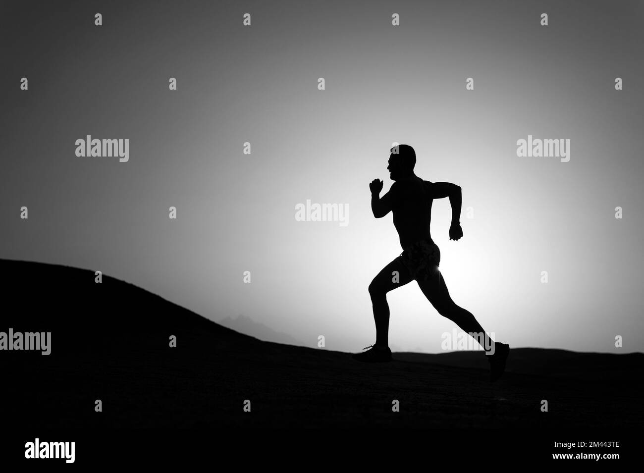 running man silhouette at sunset sky Stock Photo - Alamy
