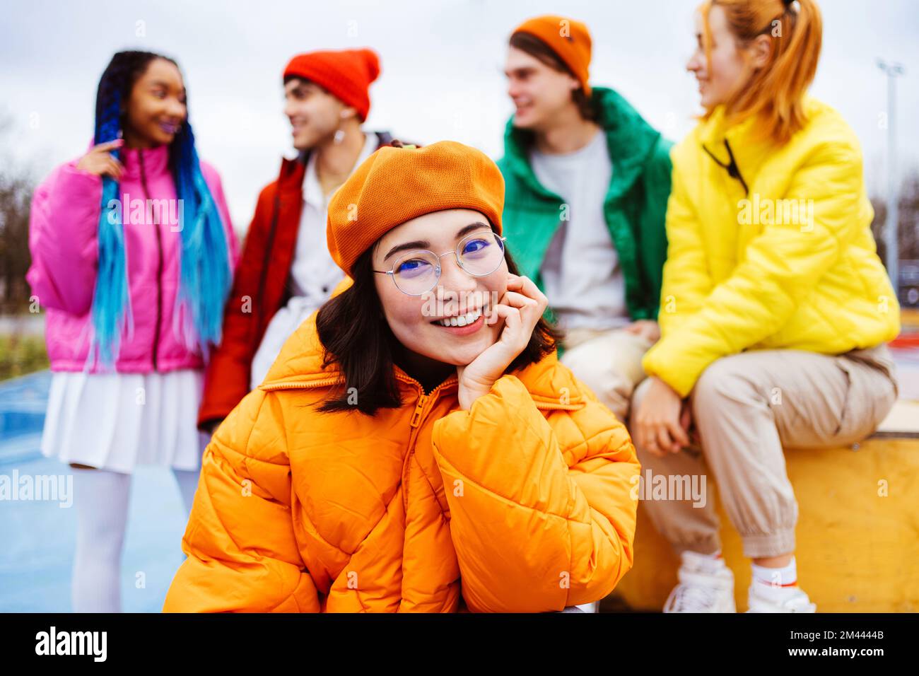 Multiracial group of young happy friends meeting outdoors in winter ...