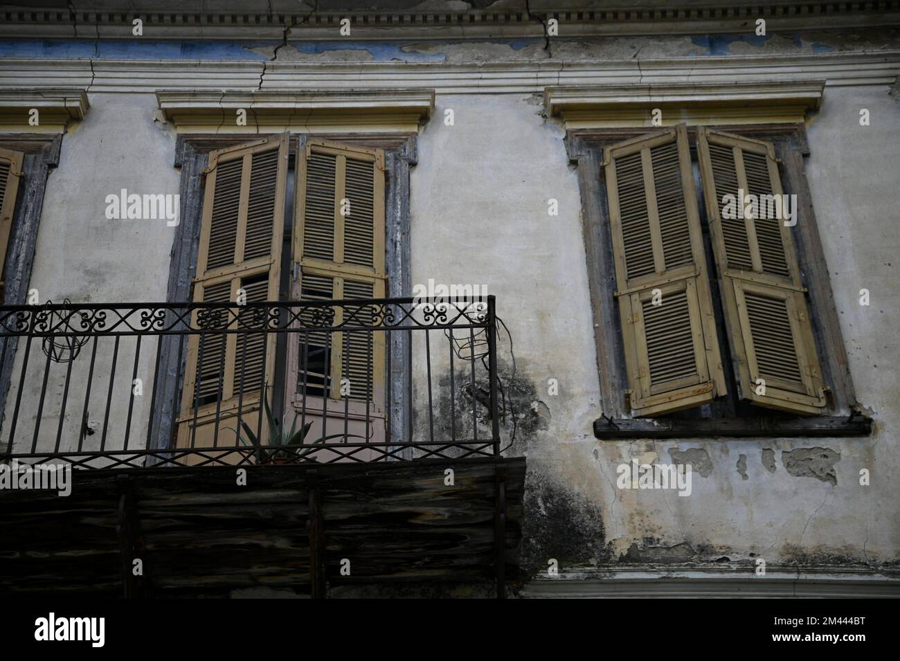 Old Neoclassical house facade with wooden window shutters and a balcony ...