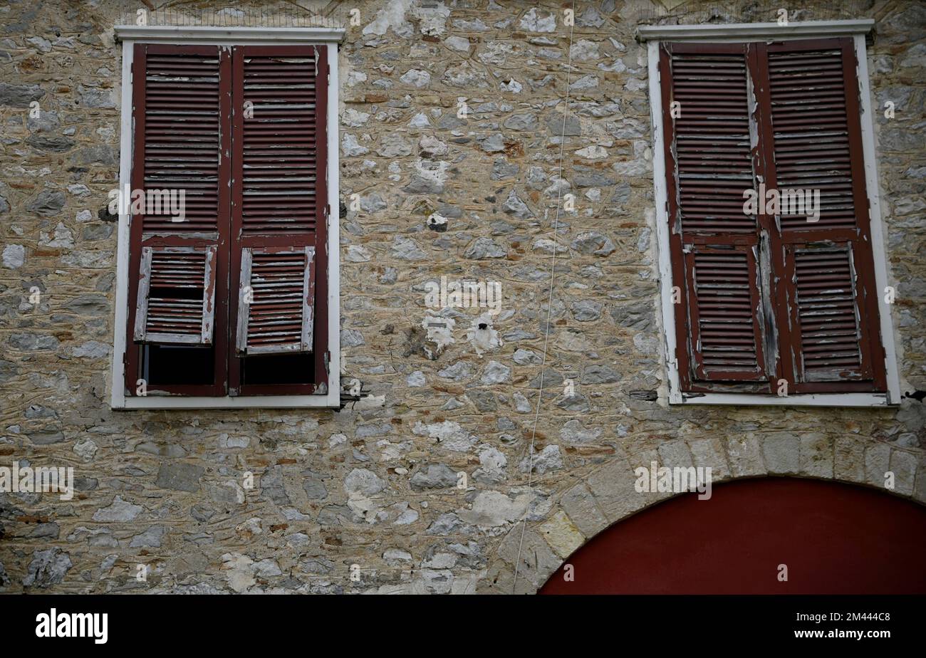 Old rural building with antique wooden window shutters on a handcrafted ...