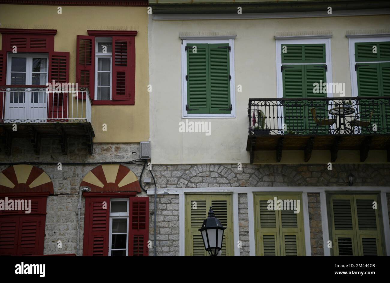 Neoclassical house facade with wooden window shutters and a balcony ...