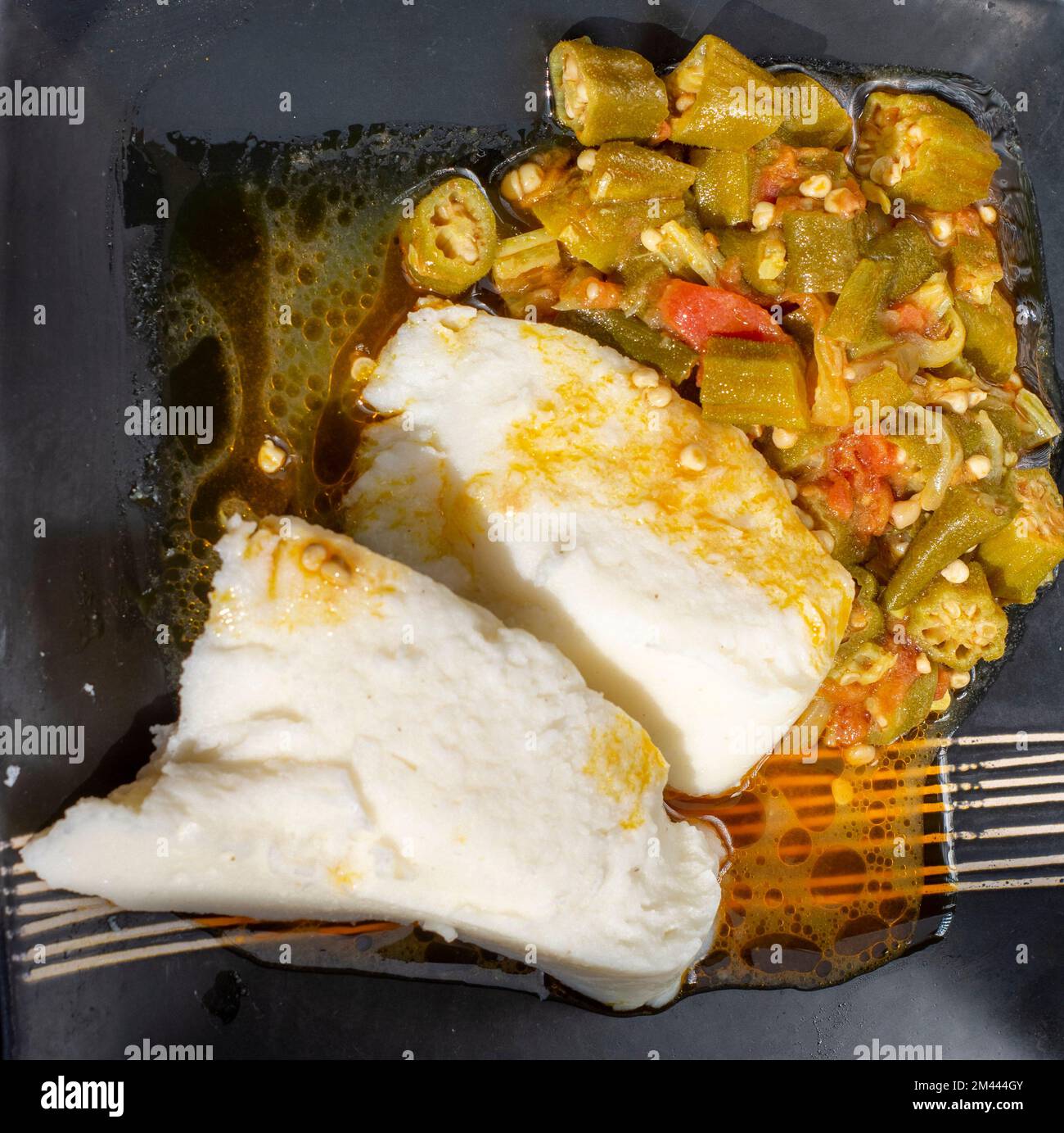 Cornmeal dish known as Ugali served with okra sauce Stock Photo - Alamy
