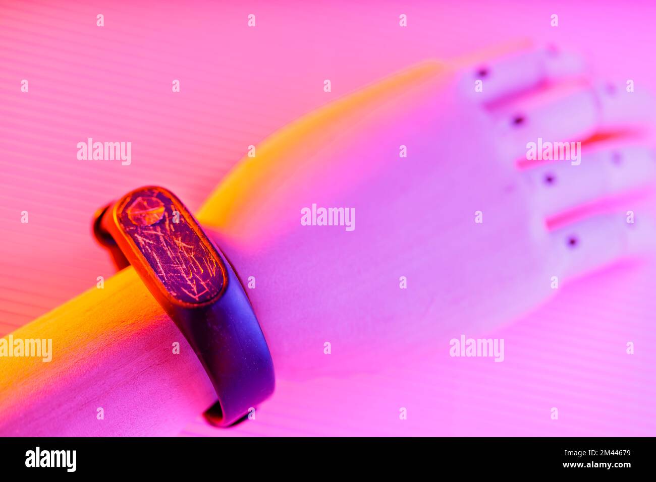 Fitness tracker with broken display on an artificial hand. Concept of ...