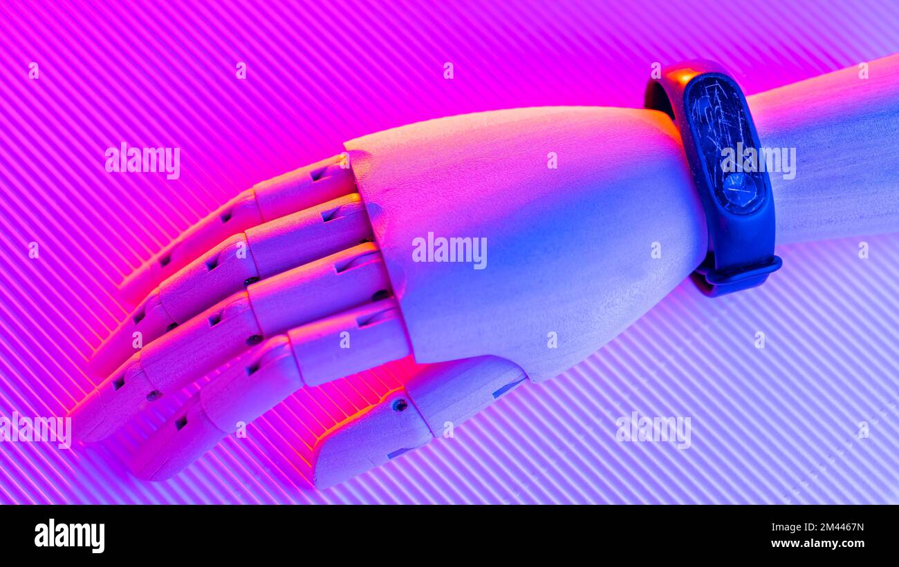 Fitness tracker with broken display on an artificial hand. Concept of ...