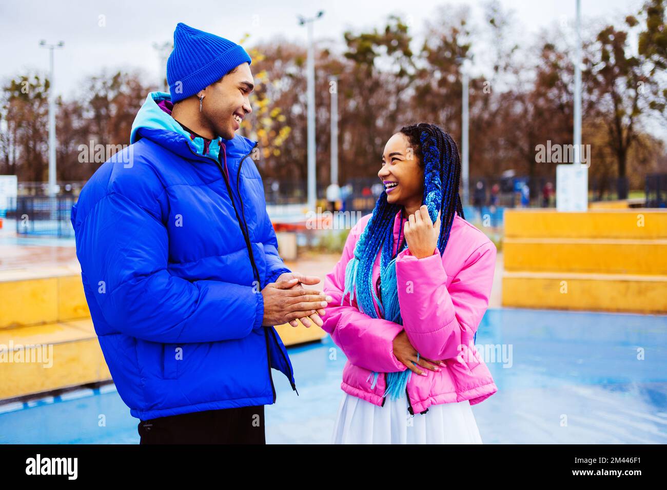 Multiracial young couple of lovers dating outdoors in winter, wearing ...