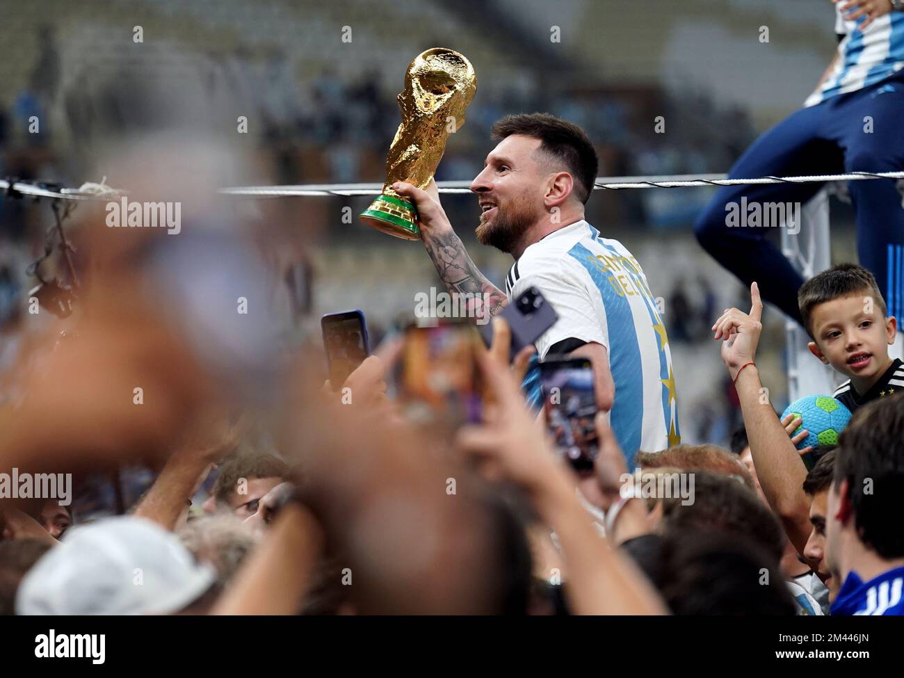Argentina's Lionel Messi celebrates with the FIFA World Cup Trophy ...