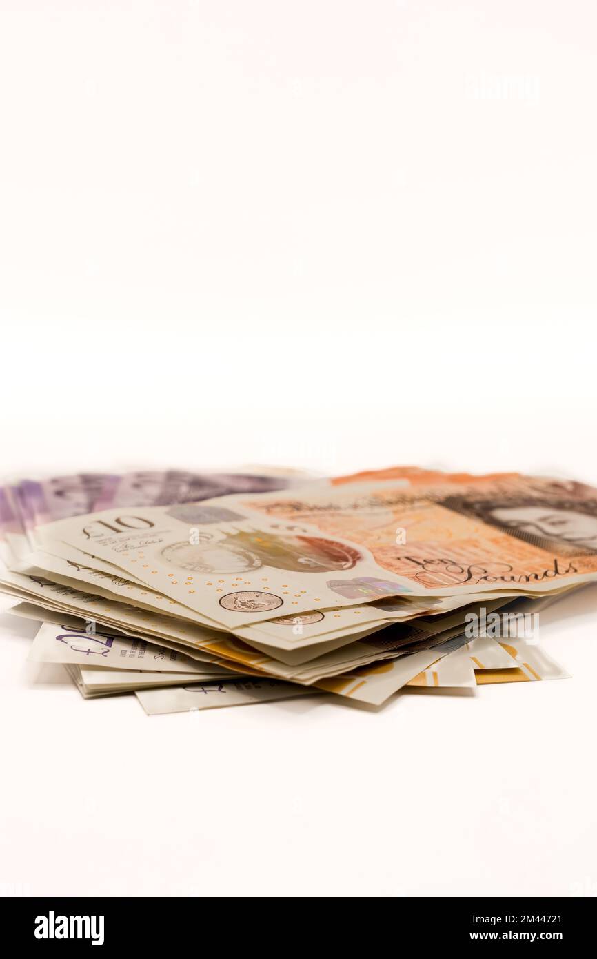 a detailed close-up of new fanned plastic GBP £ Sterling 10 Ten and 20 ...