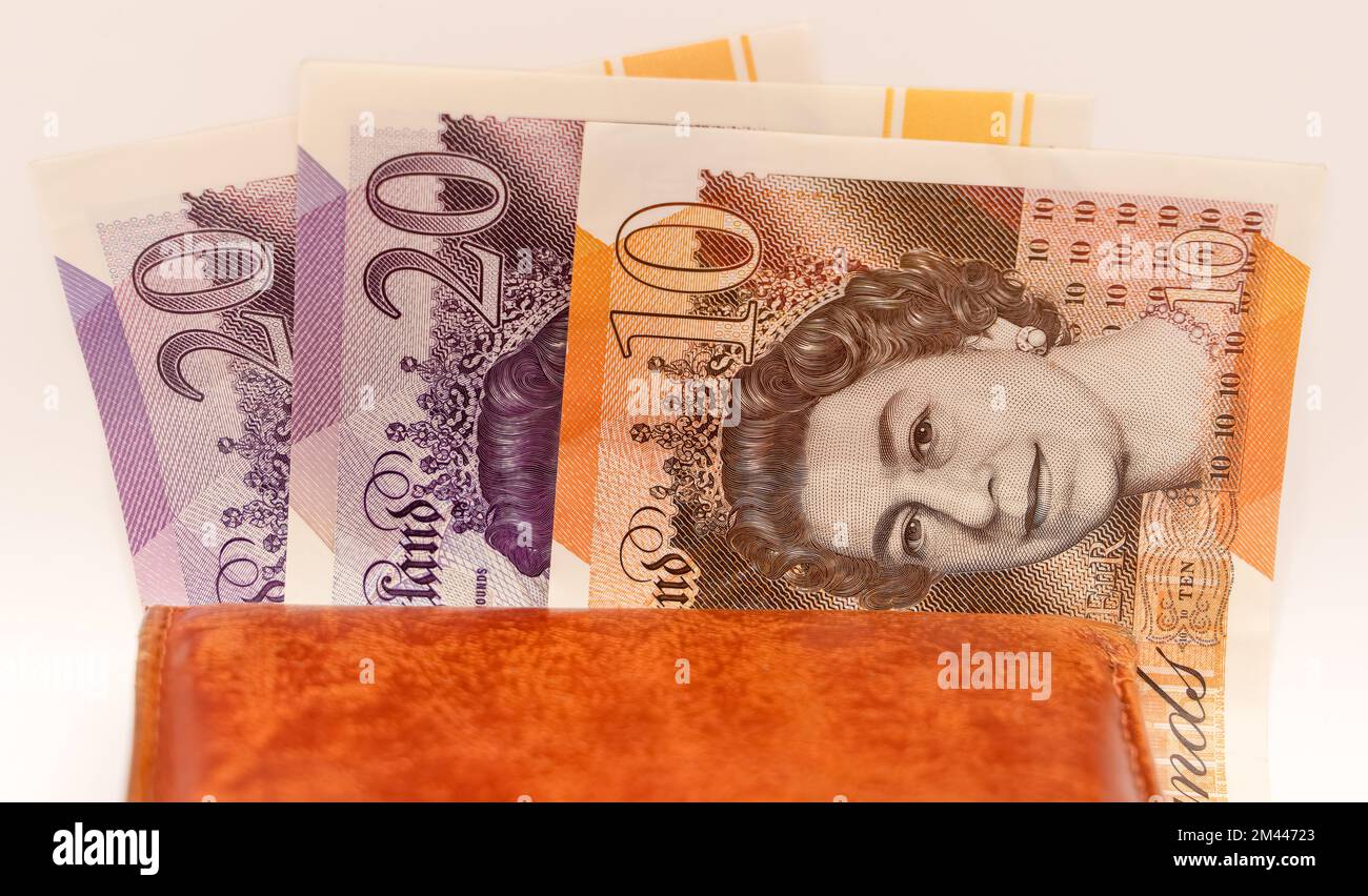 a light brown leather wallet with bank cards and a detailed close-up of ...