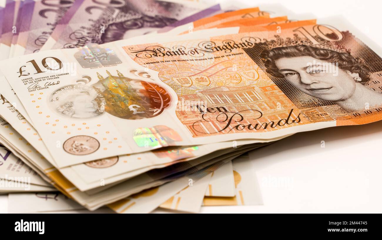 a detailed close-up of new fanned plastic GBP £ Sterling 10 Ten and 20 ...