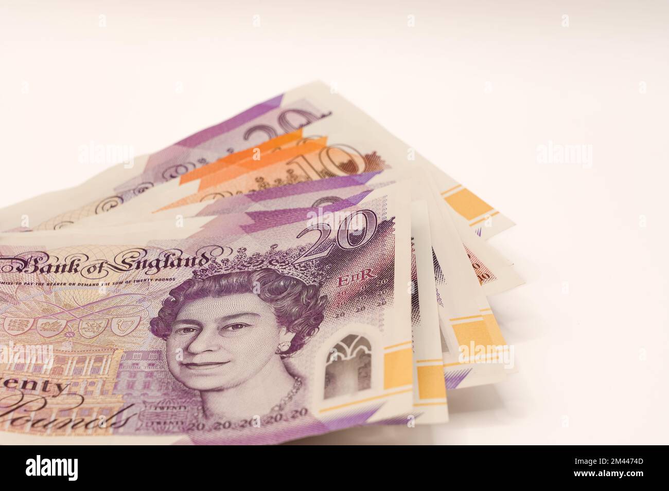 a detailed close-up of new fanned plastic GBP £ Sterling 10 Ten and 20 ...