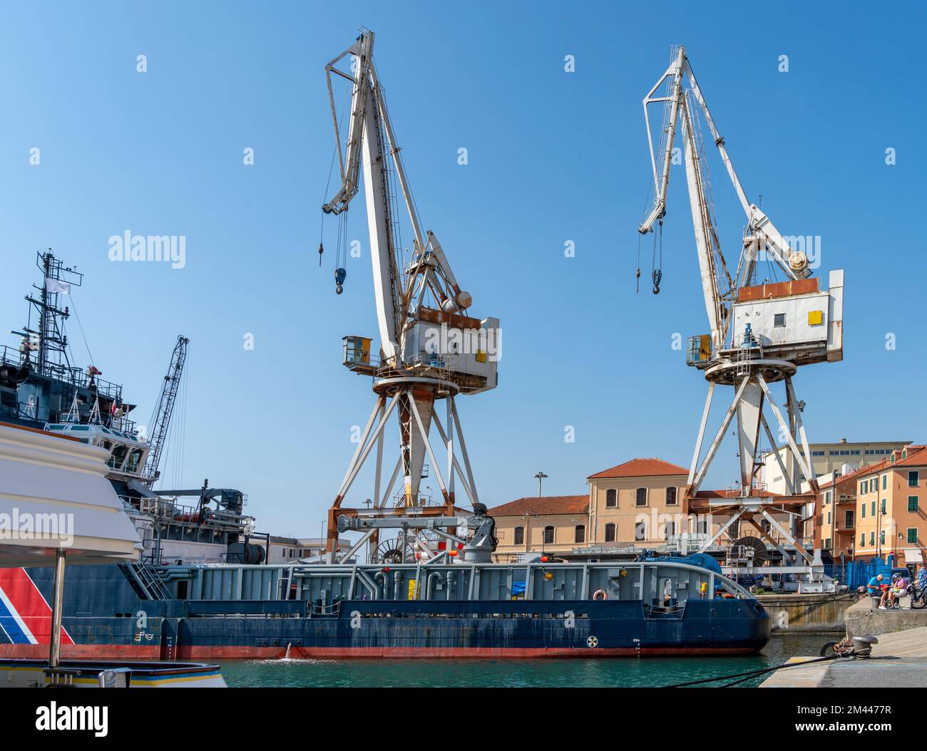 Work boat and dock cranes seen in Imperia, a coastal city in Liguria ...