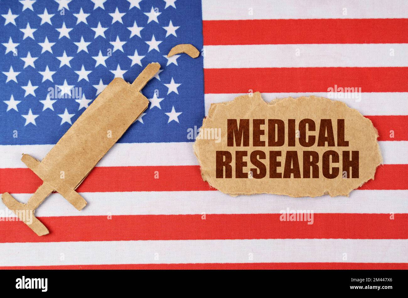 Medical concept. On the US flag there is a cardboard figure of a ...