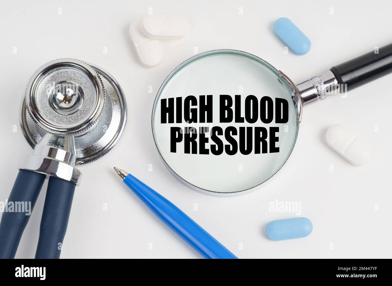 Medicine and health concept. On a white surface lie pills, a pen, a ...