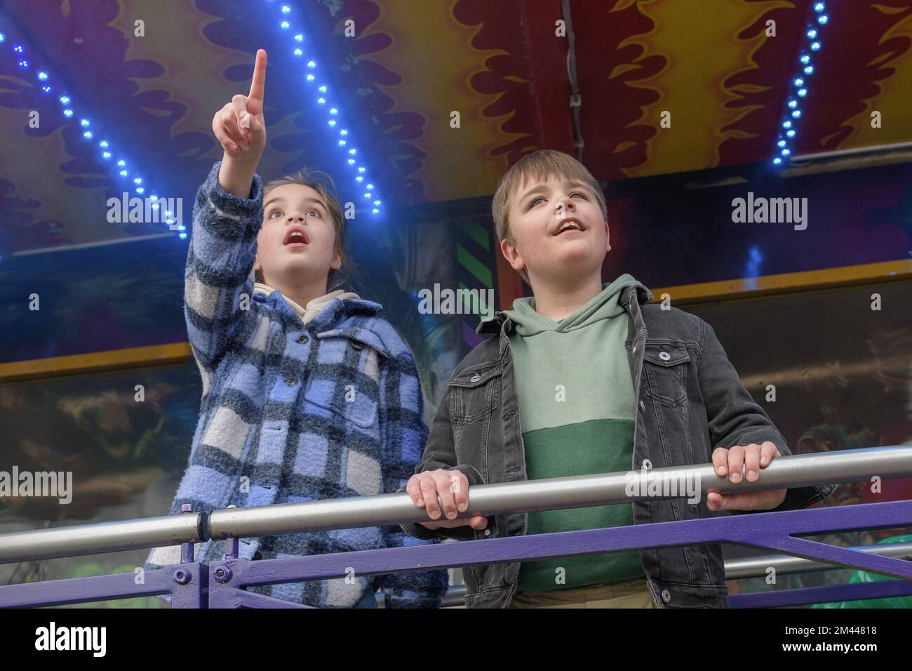 Amazing emotions. Teenage girl and boy. On the carousel in the ...