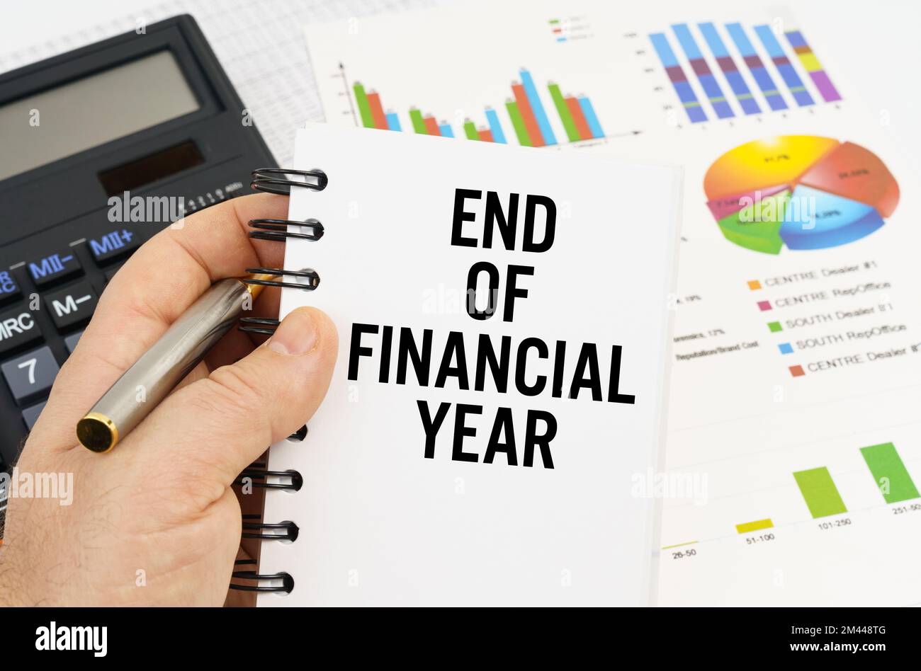 Finance and economics concept. The man is holding a pen and a notebook ...