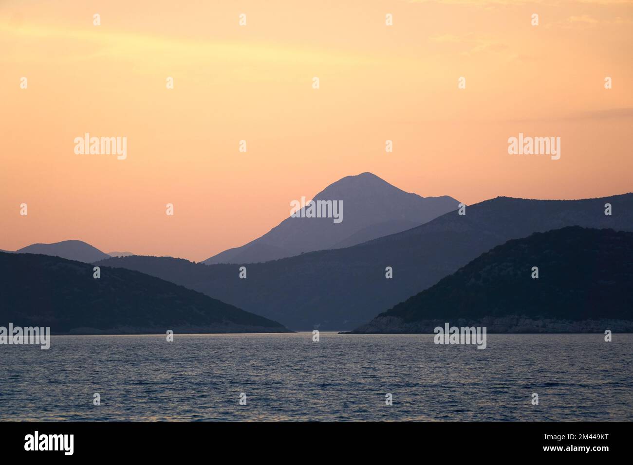 A picturesque view of silhouettes of hills on a sunset sky background ...
