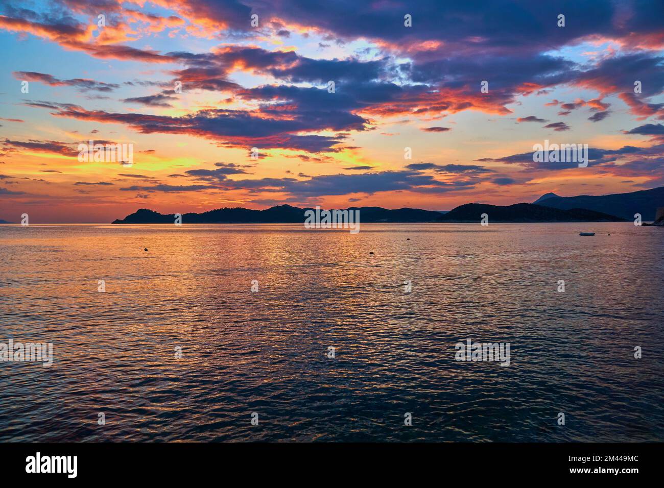 A beautiful fiery orange sunset sky over the calm sea Stock Photo - Alamy