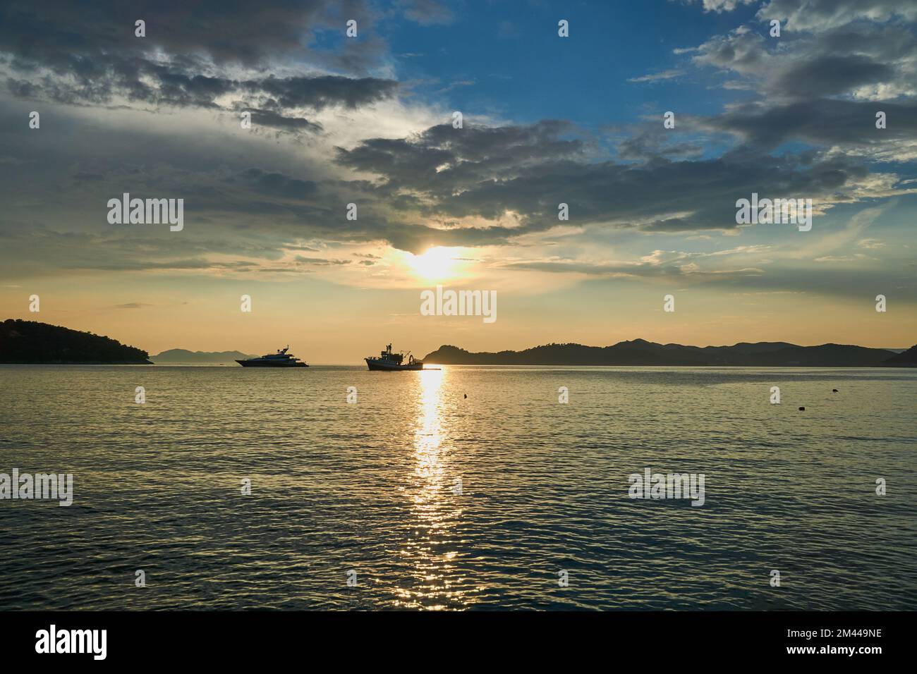 A panoramic view of silhouettes of yachts floating on the sea under the ...