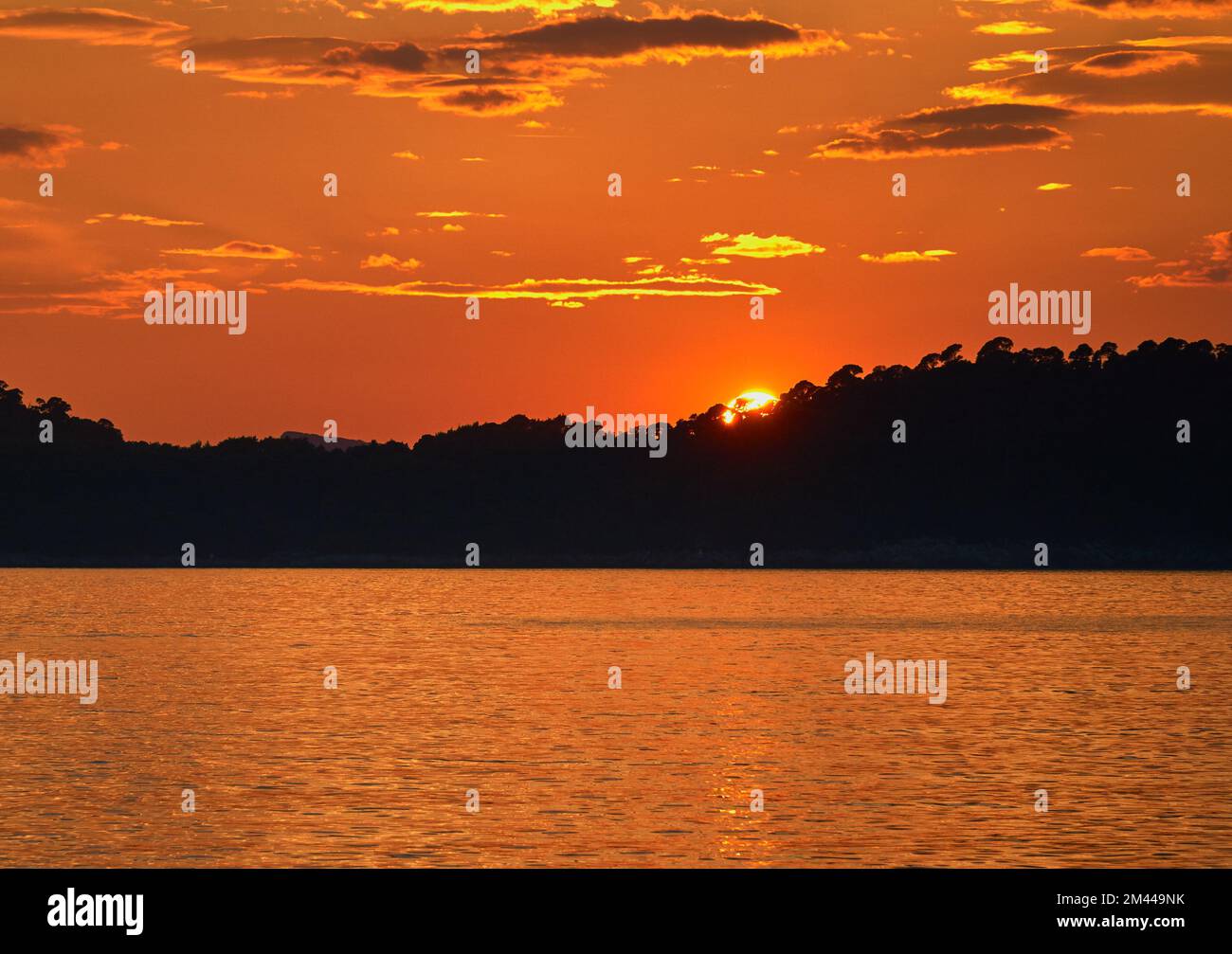 A picturesque view of strong sunset with a beautiful golden lining of ...