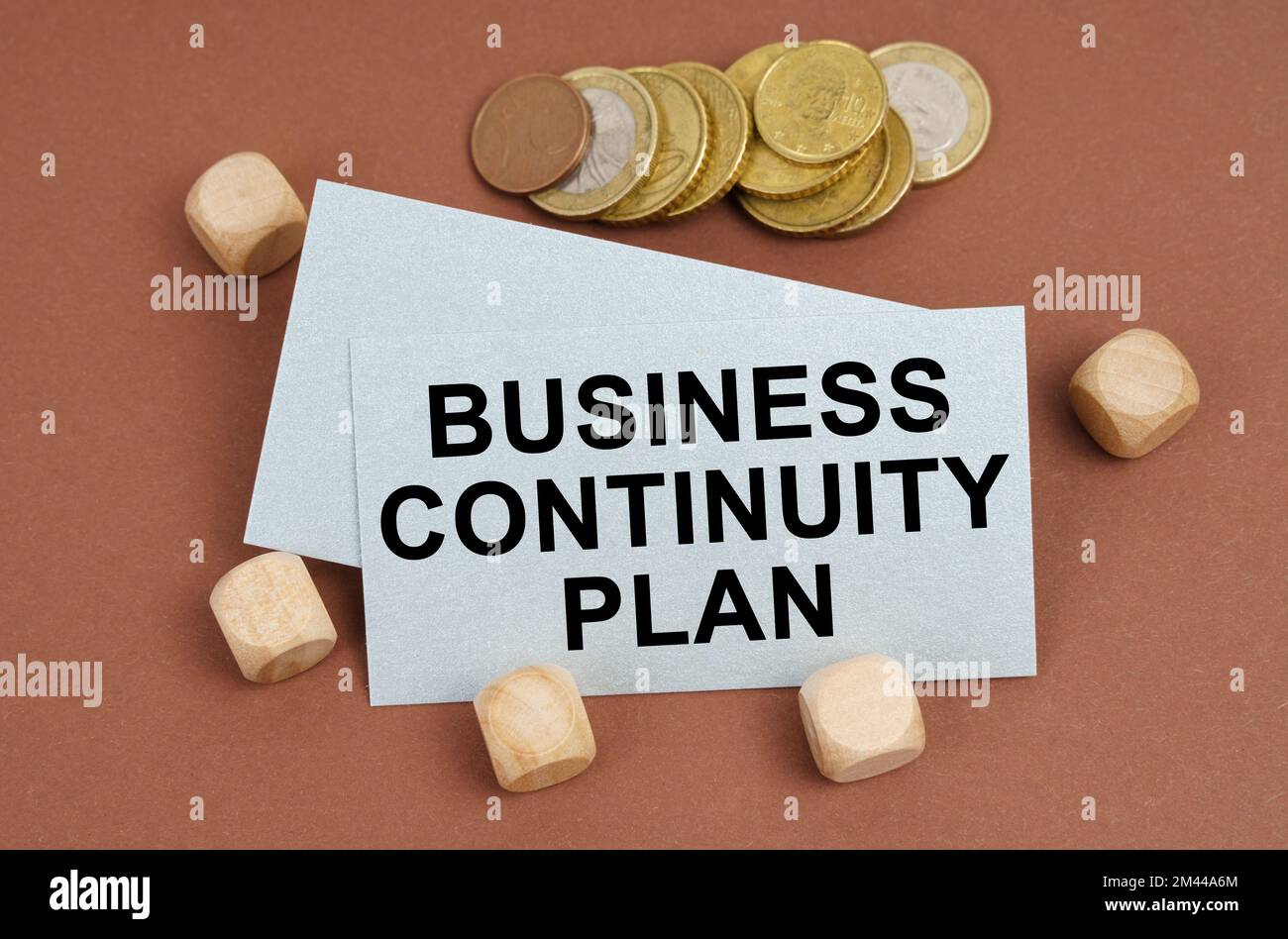 Business and finance concept. On a brown surface are coins, cubes and a ...