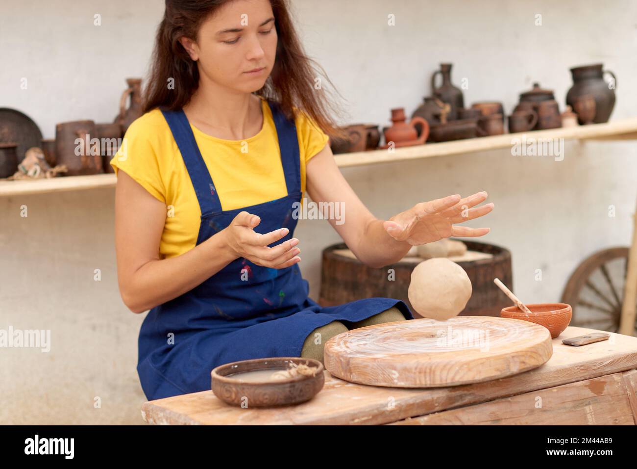 creating right sphere shape from clay for the manufacture of pottery ...