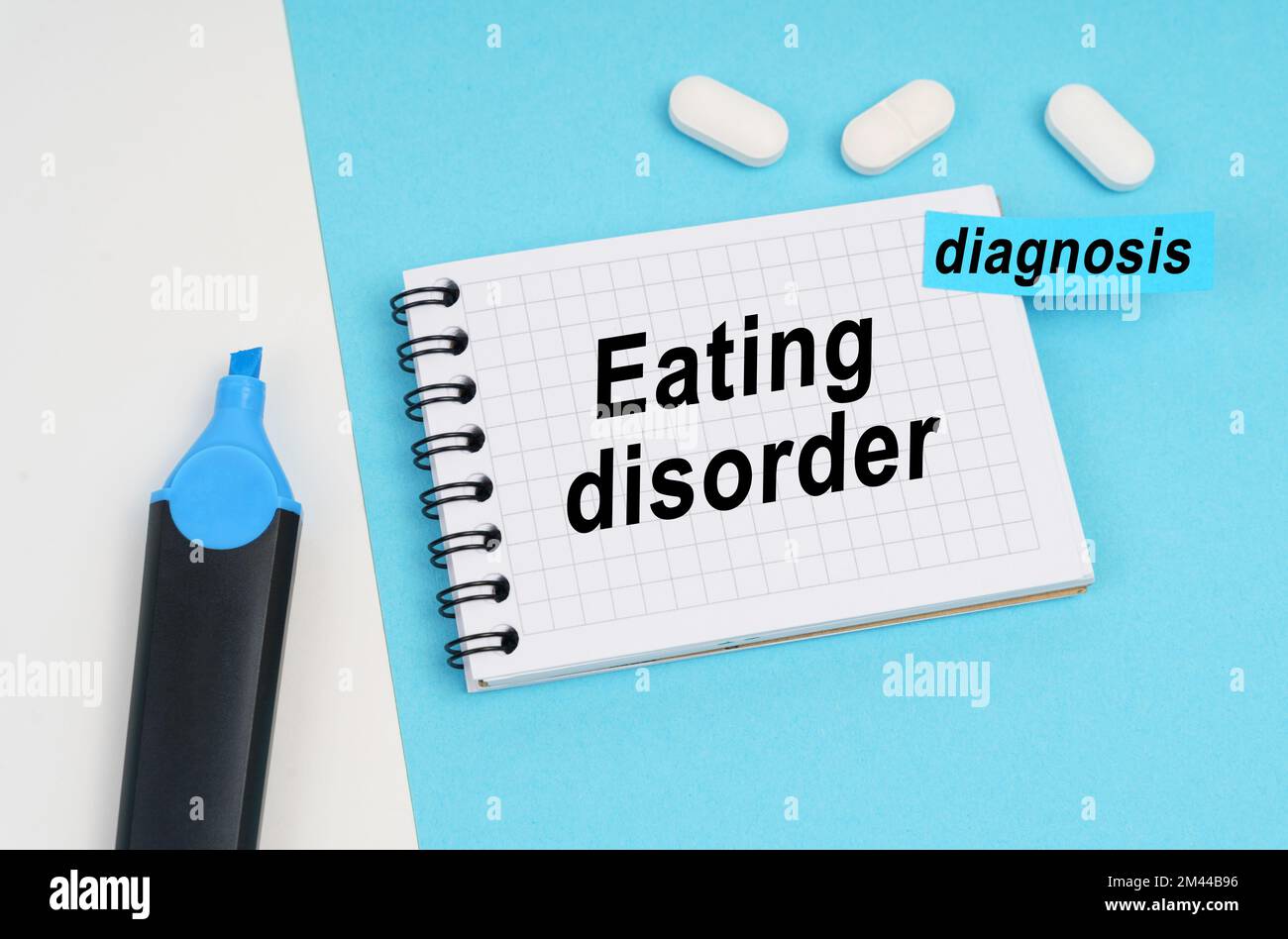 Medicine and health concept. On a white and blue surface are pills, a ...