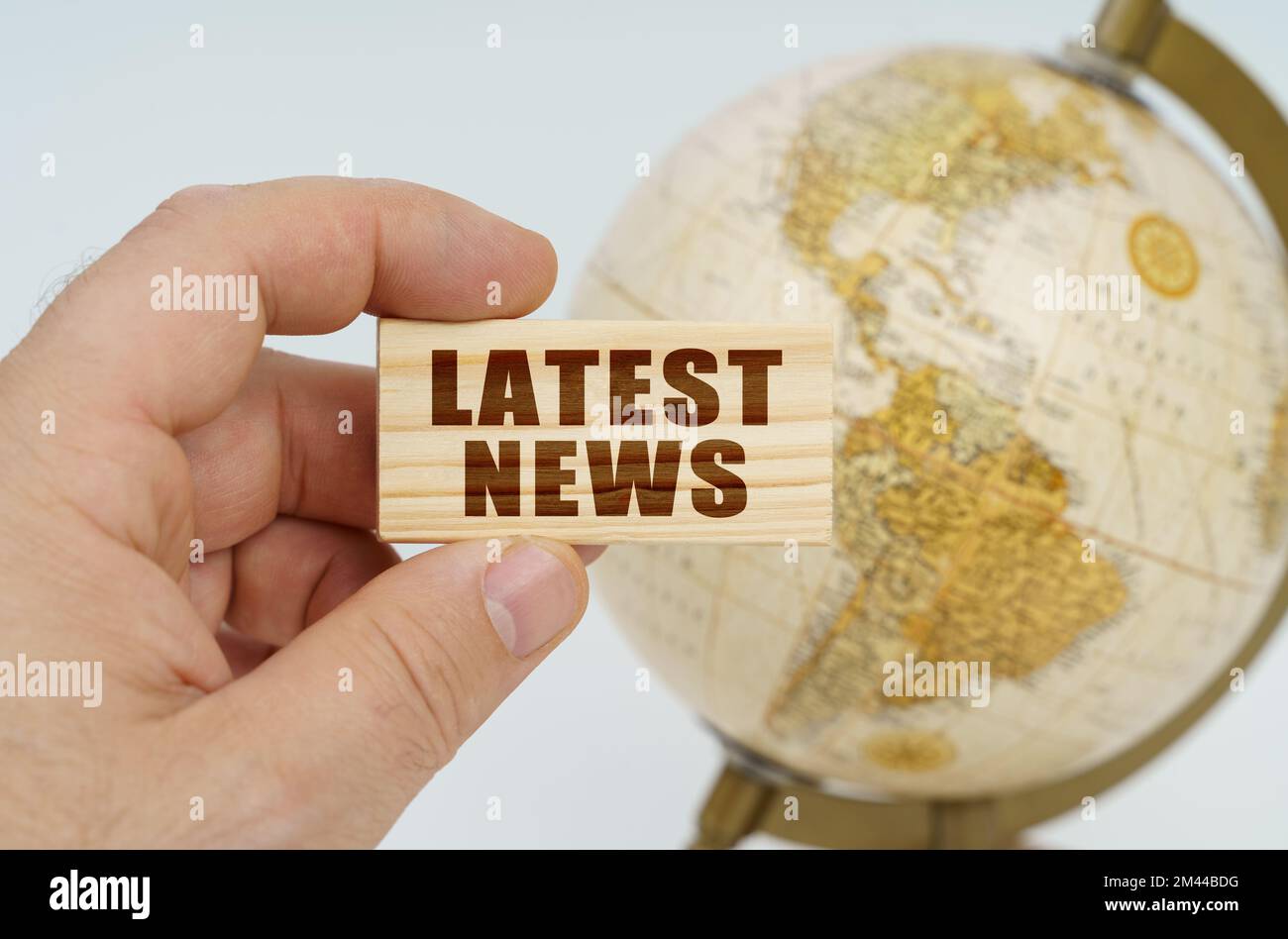 Globalization concept. A man holds in his hand a wooden plate on which ...