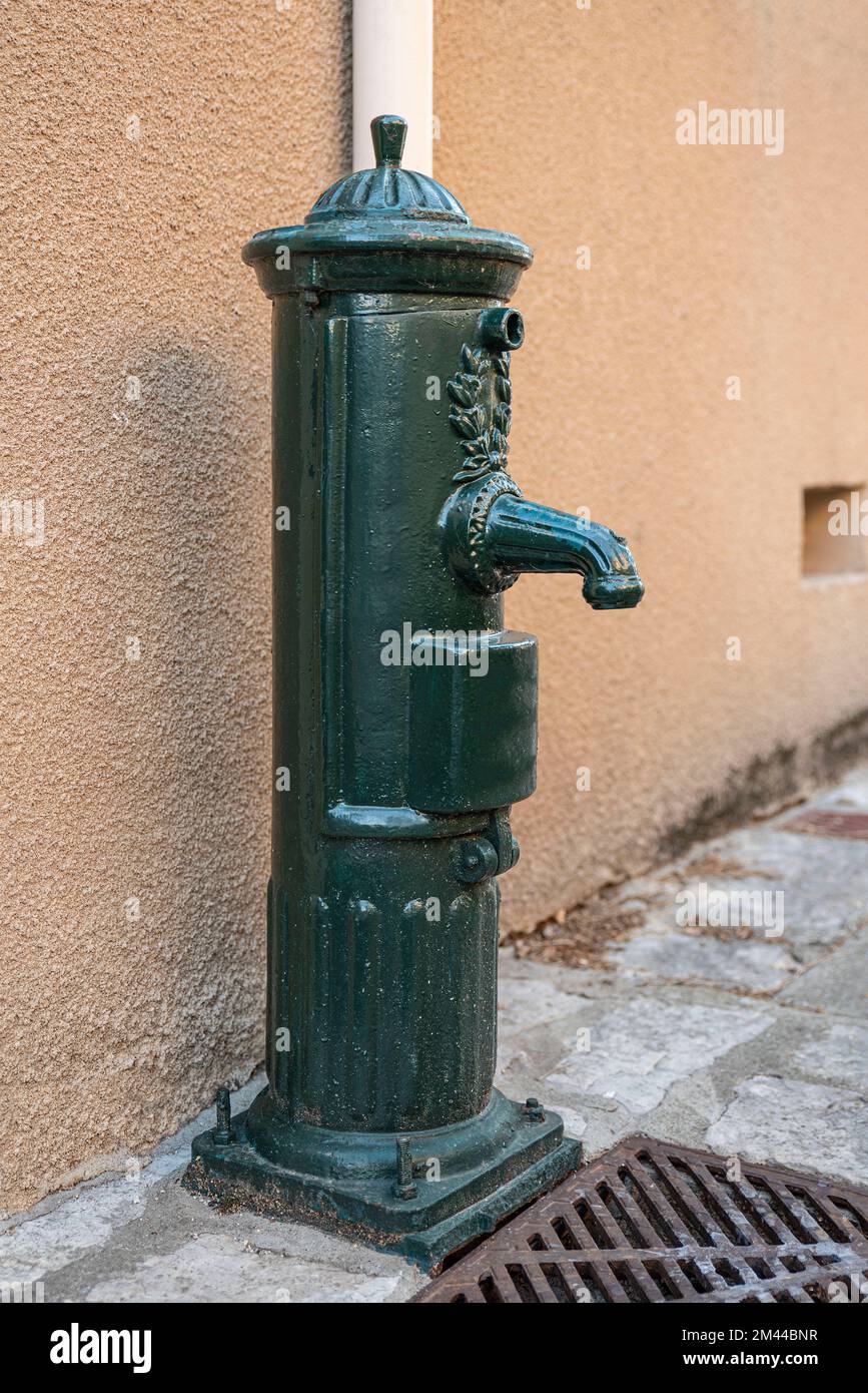 Old green hydrant with a tap Stock Photo - Alamy