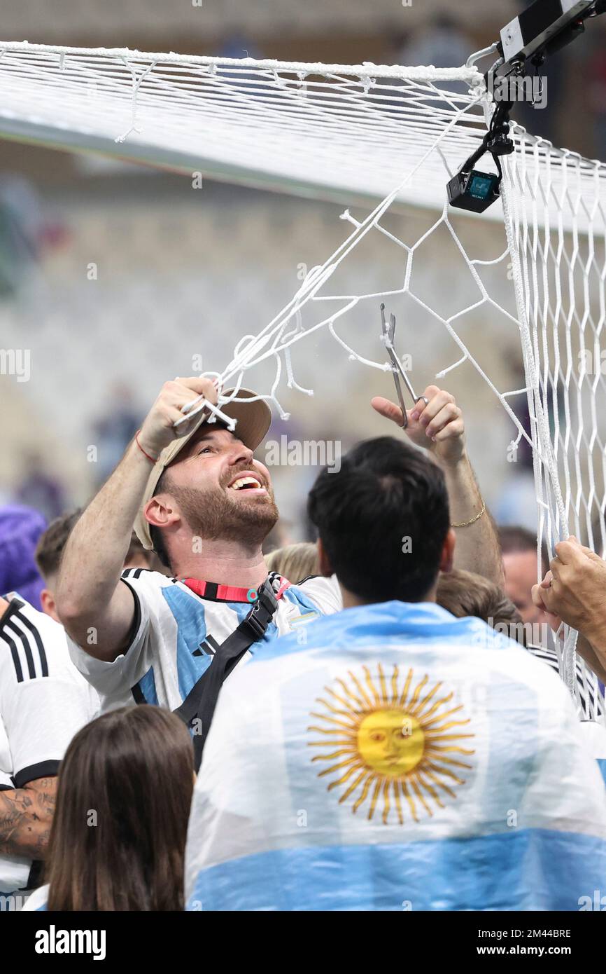 Lusaier, Qatar. 18th Dec, 2022. Argentina fans take parts of a goal net ...