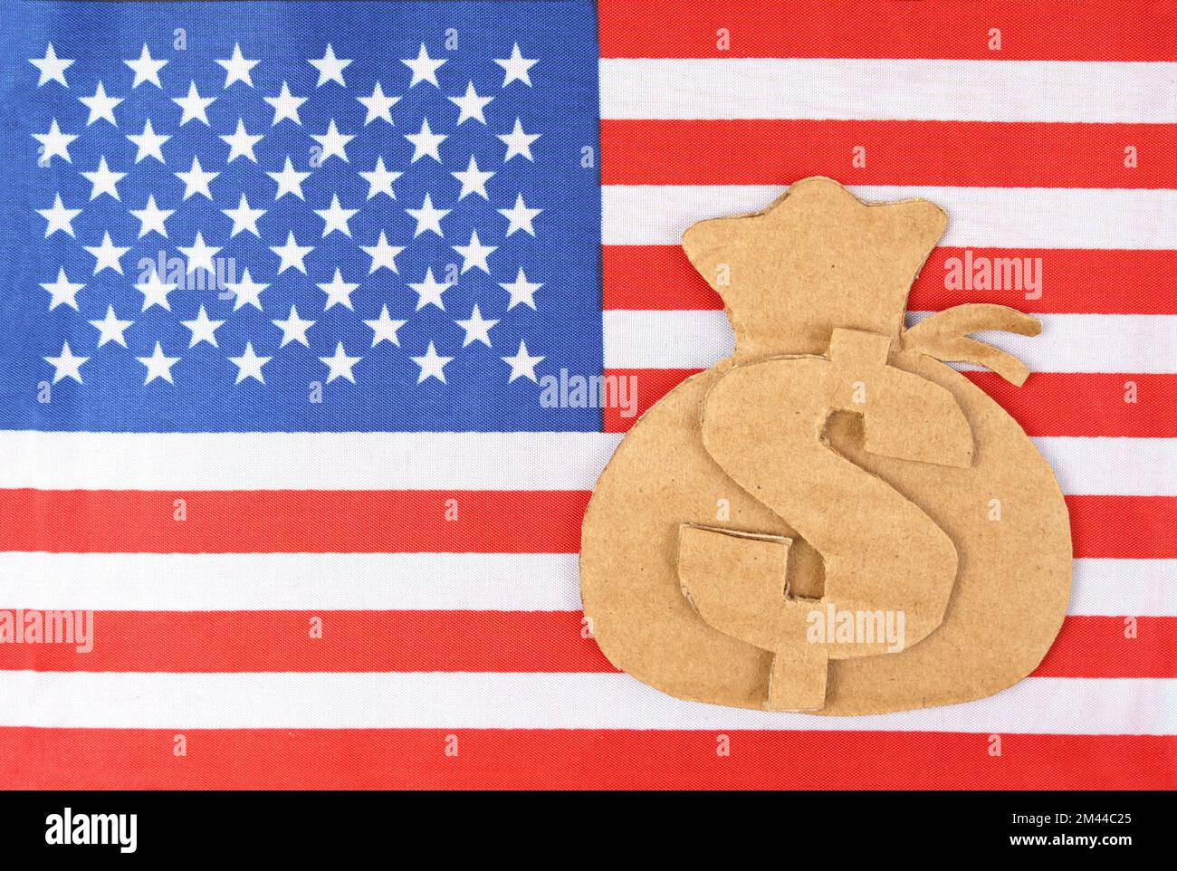 Economic concept. On the flag of the United States lies a bag cut out ...