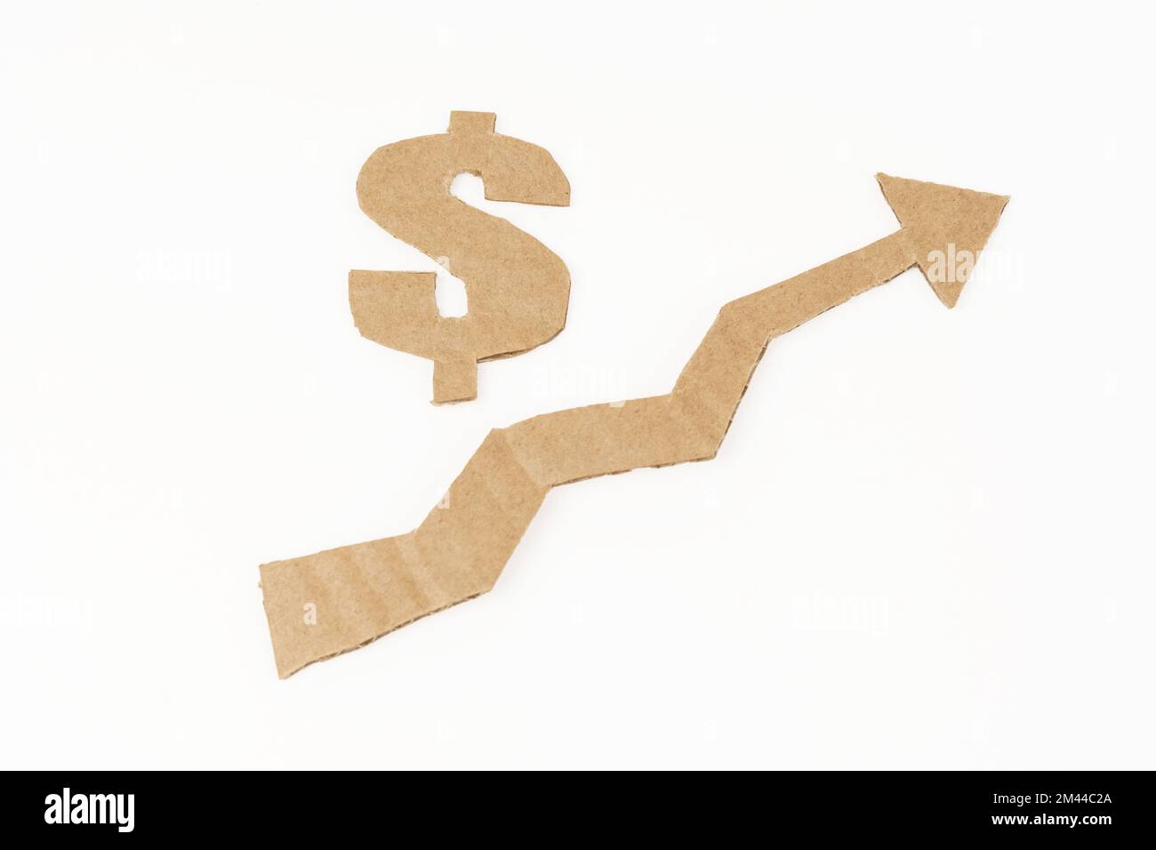 The concept of economic growth. On a white surface, a graph with an up arrow and a dollar symbol ...
