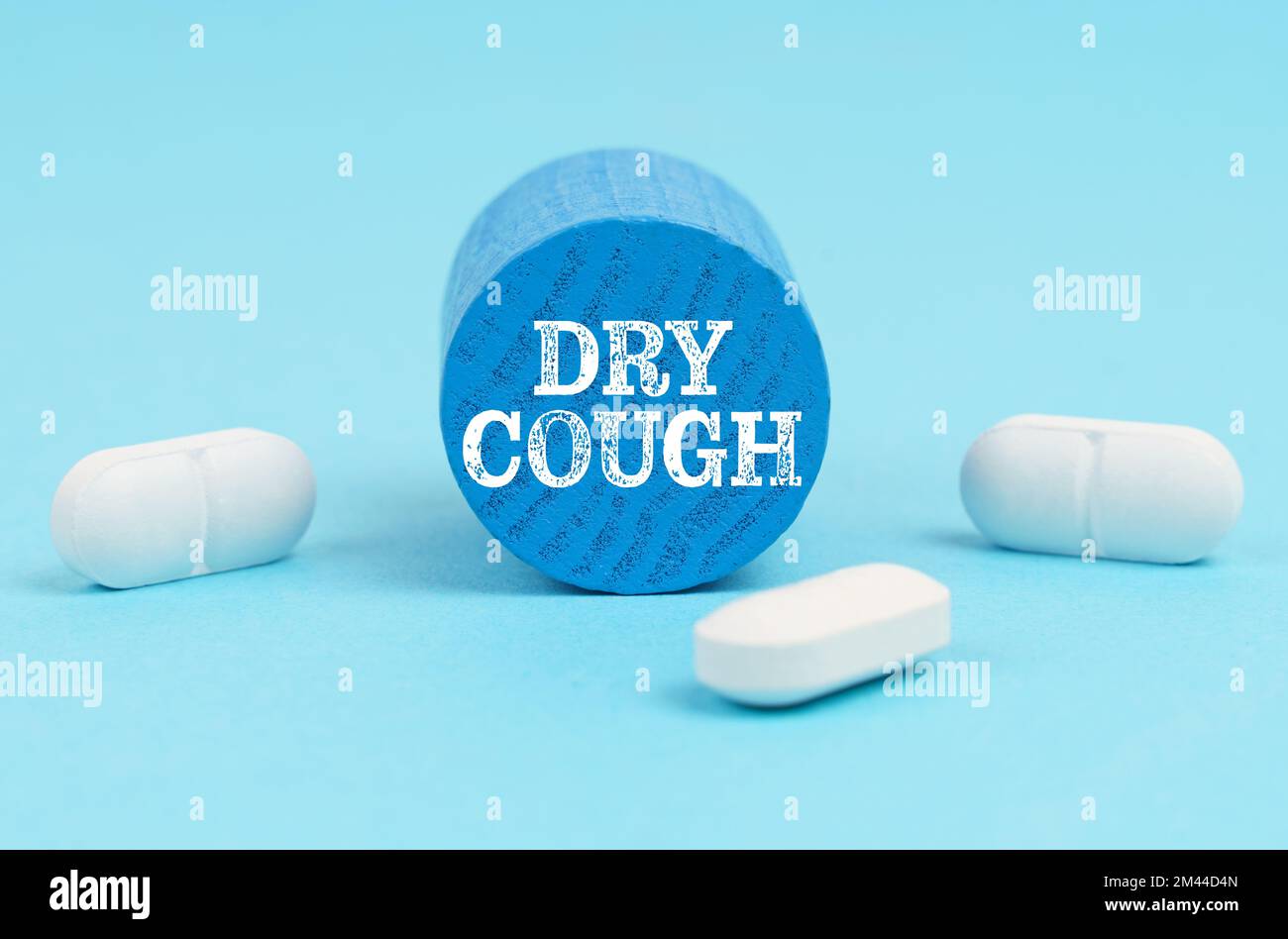 Medicine and health concept. Pills lie on a blue surface, a wooden blue ...